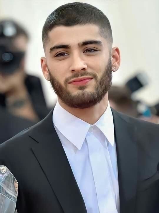 Oval faced model demonstrating versatile buzz cut style